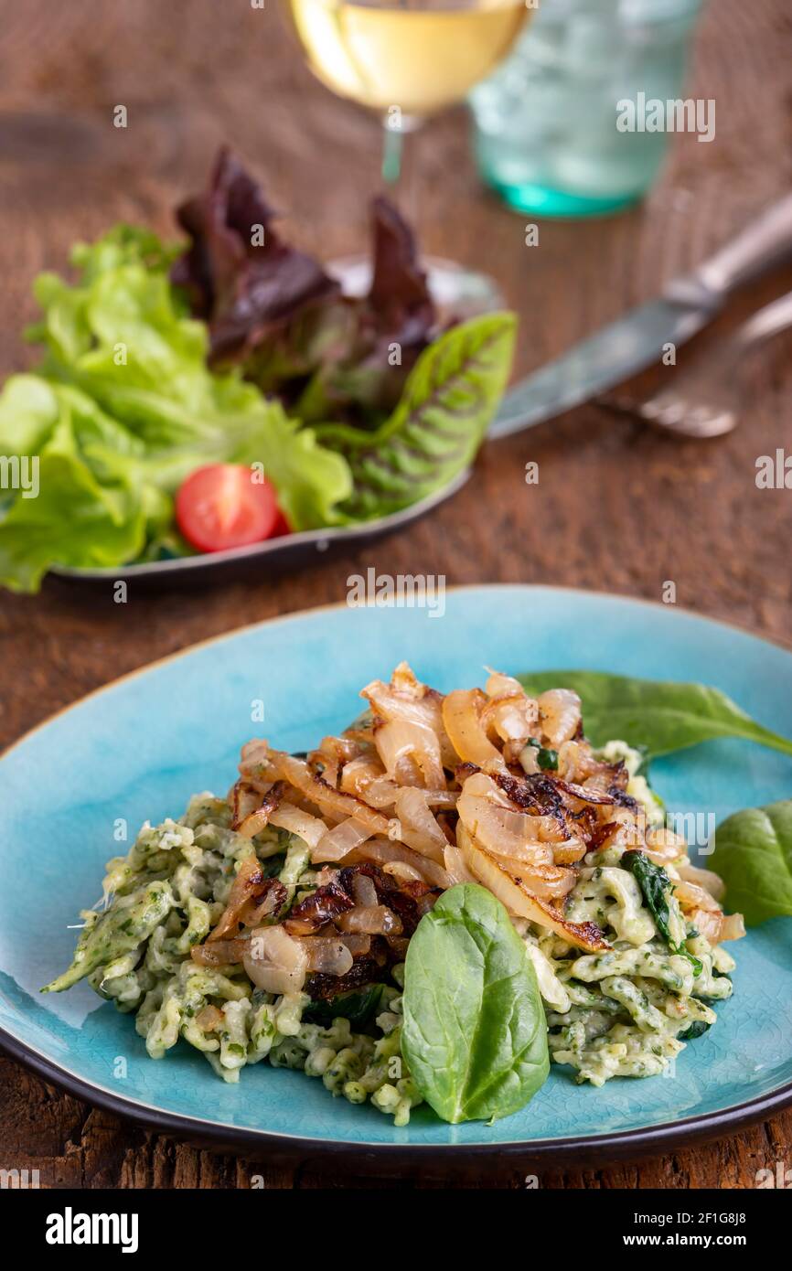 bavarian spinach spaetzle on wood Stock Photo - Alamy