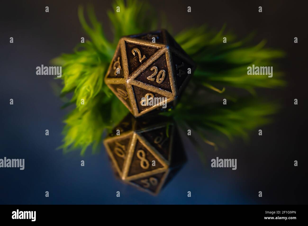 A close-up photo of a 20-sided die on a reflective surface with in the ...