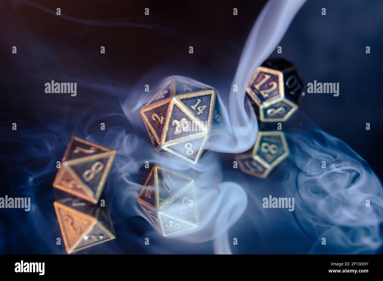 Image of smoke flowing and surrounding bronze rpg dice on a reflective ...