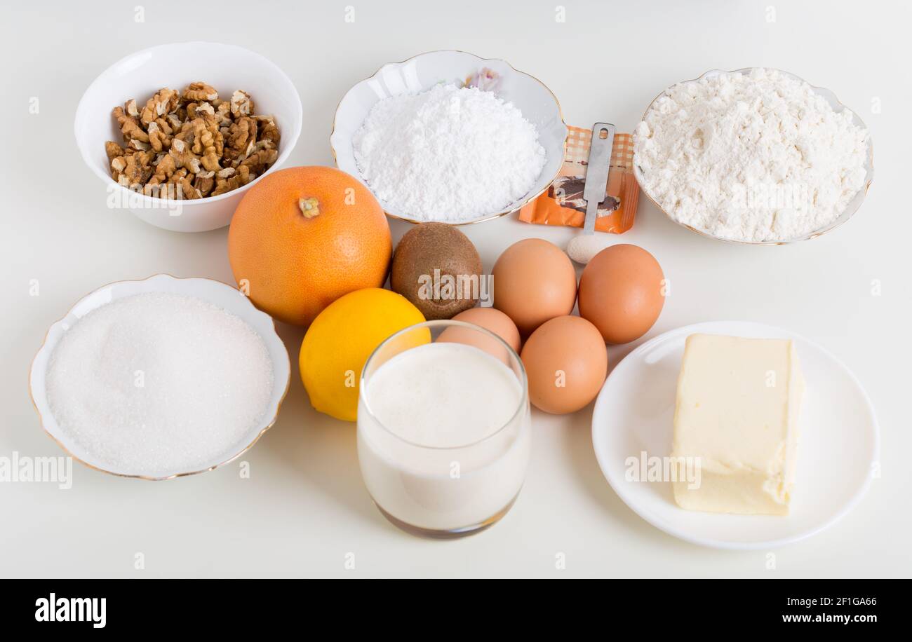 Various ingredients for baking cake. Located on a white background ...