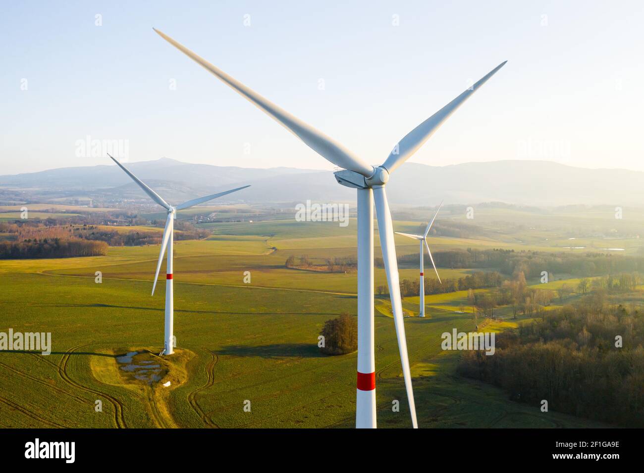Panoramic view of wind farm or wind park, with high wind turbines for ...