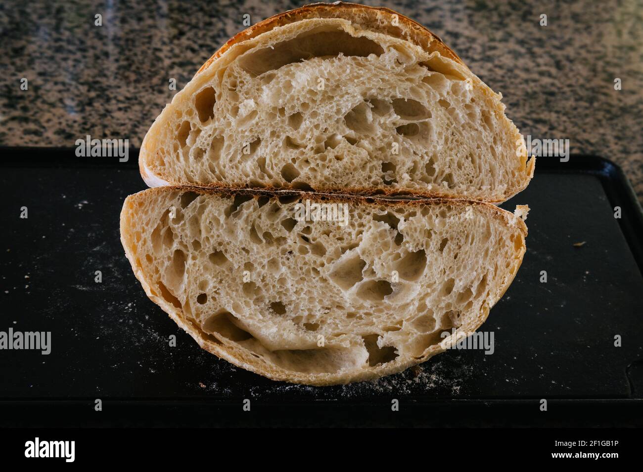 Crusty sourdough bread loaf, baked, resting on pan, ready to eat ...