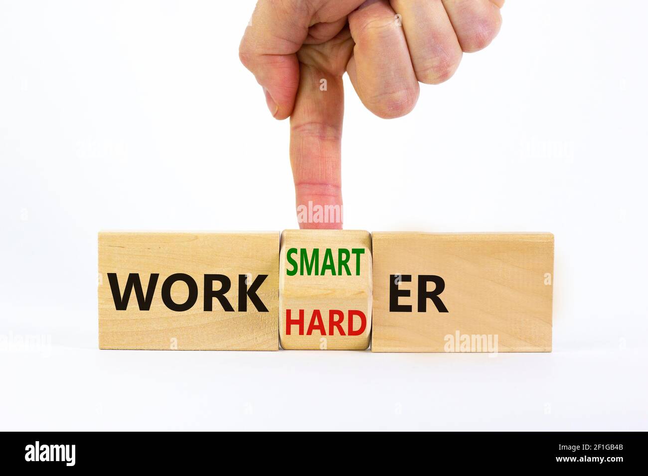 Work harder or smarter symbol. Businessman turns wooden block and ...