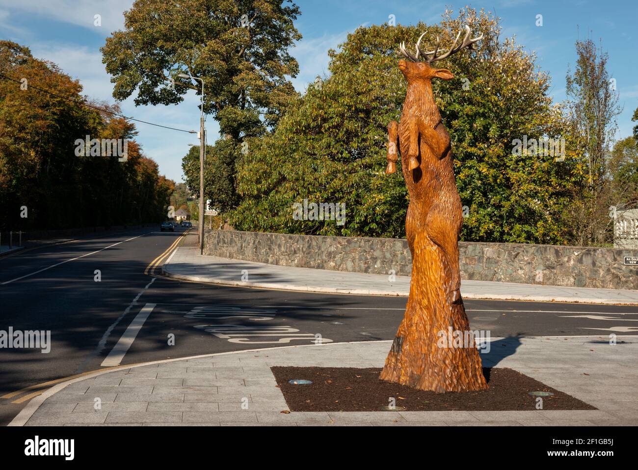 Carved wood statue of a red deer stag leaping into the air, carved ...