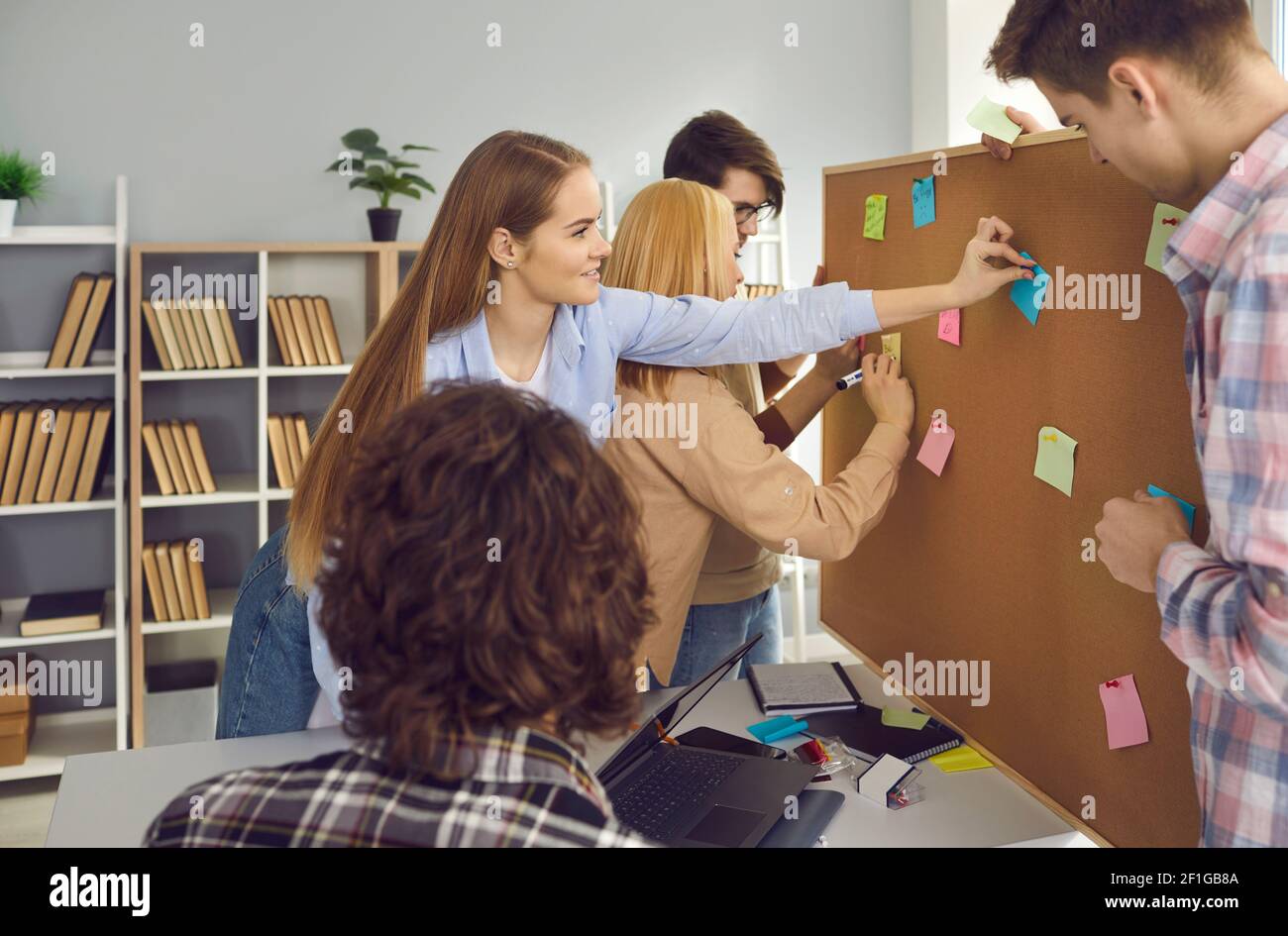 School, college or university students brainstorming while working on ...