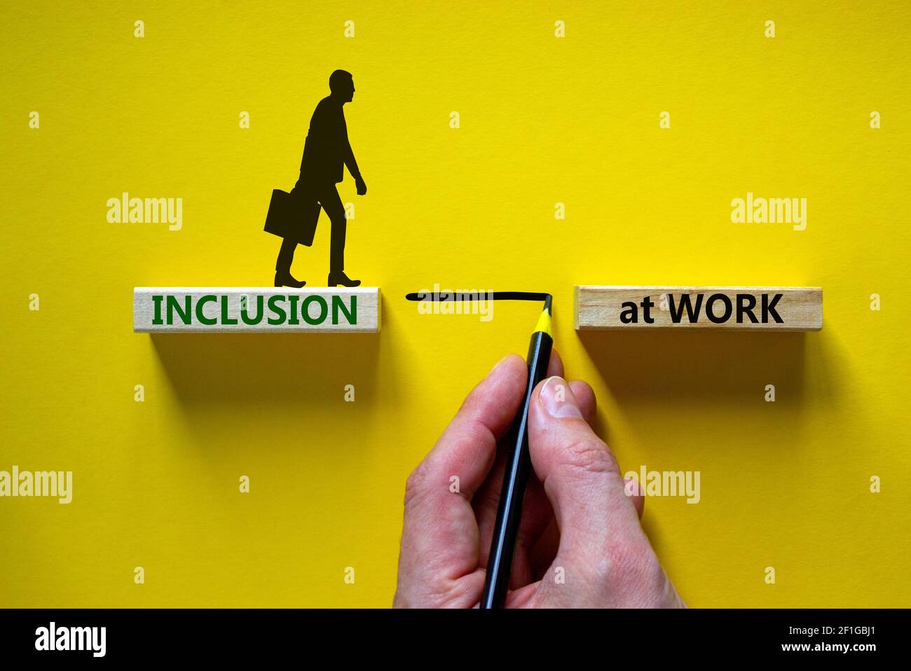 Inclusion at work symbol. Wooden blocks with words 'Inclusion at work ...