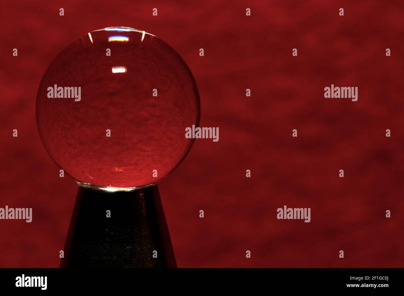 Crystal sphere in red background Stock Photo - Alamy