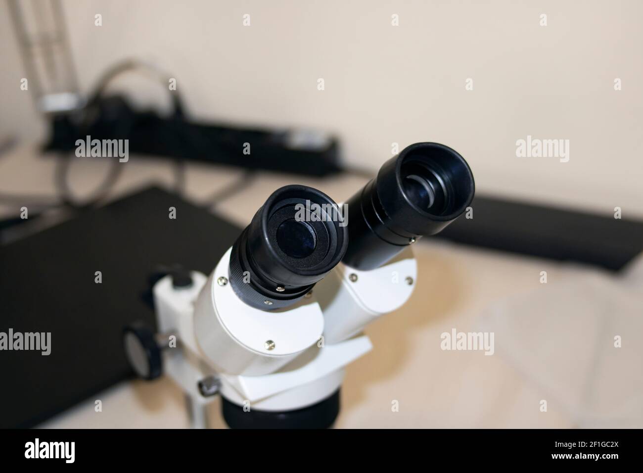 Black microscope on the wooden desktop close up Stock Photo - Alamy