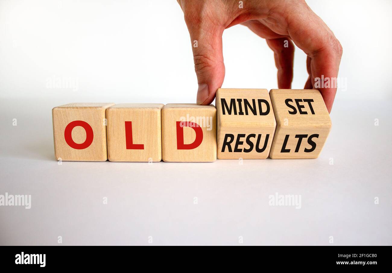 Old mindset and results symbol. Businessman turns wooden cubes and ...