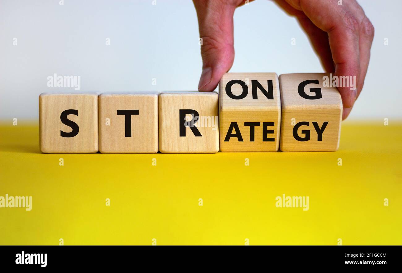 Strong strategy symbol. Businessman turns wooden cubes with words ...
