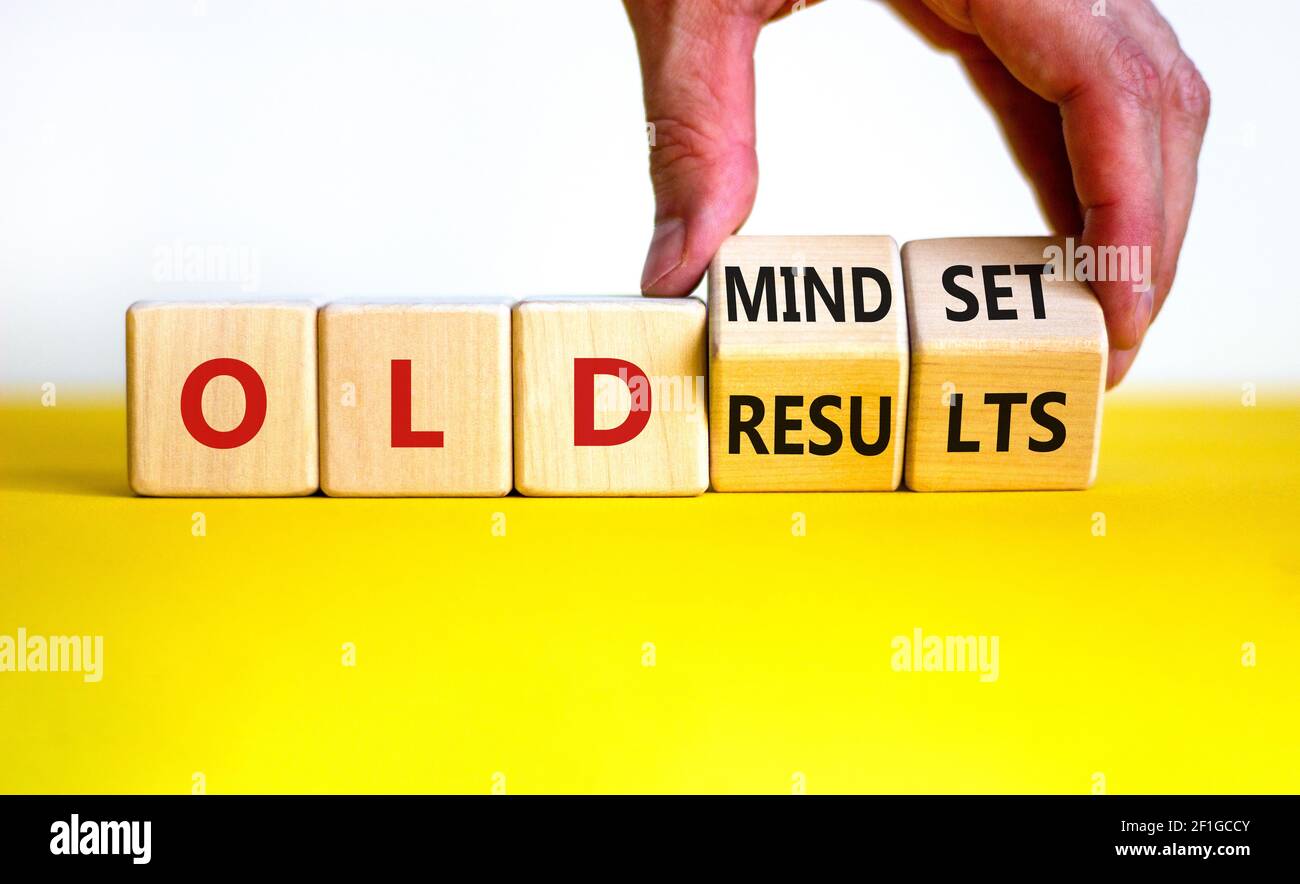Old mindset and results symbol. Businessman turns wooden cubes and ...