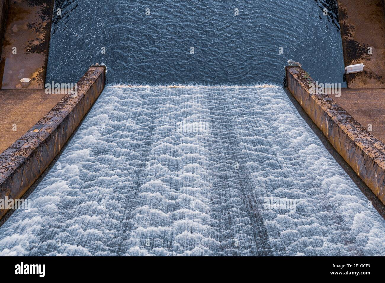 Water flowing down the dam of a reservoir Stock Photo - Alamy