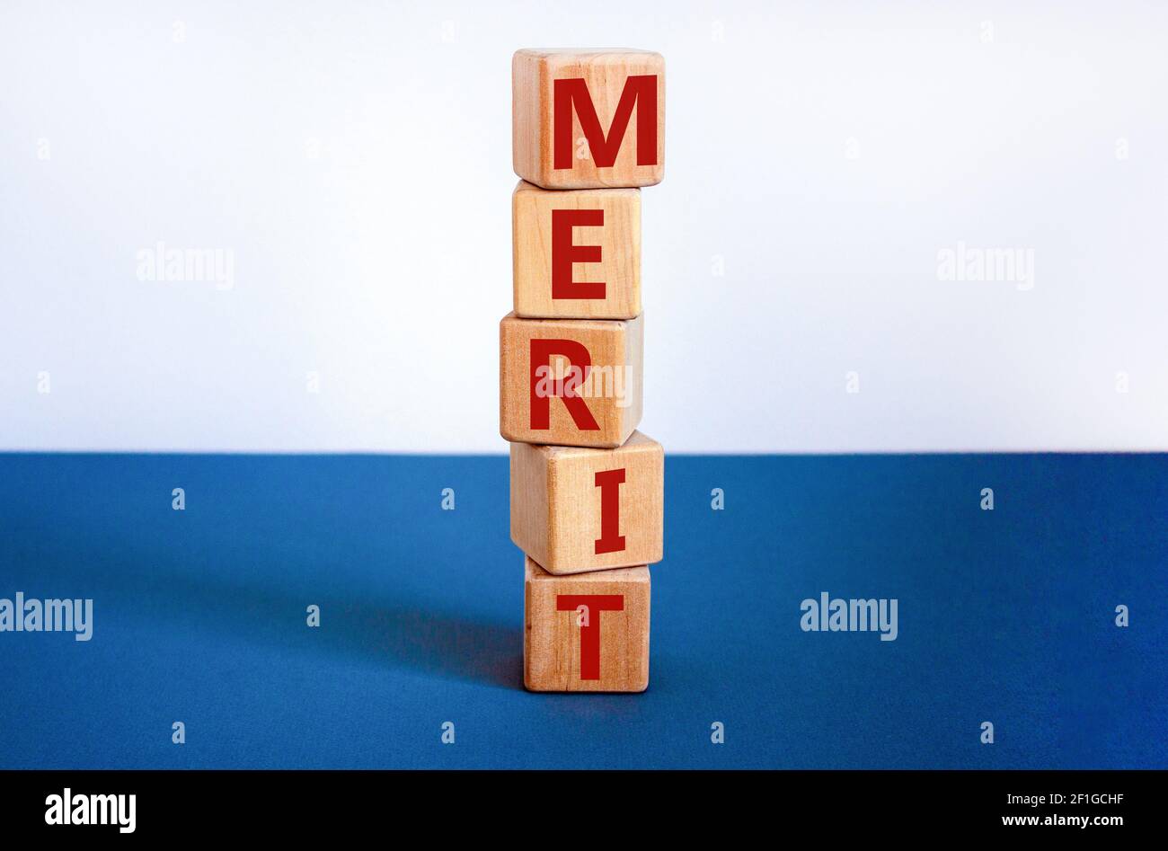 Merit symbol. Wooden cubes with the word 'merit'. Beautiful white and ...
