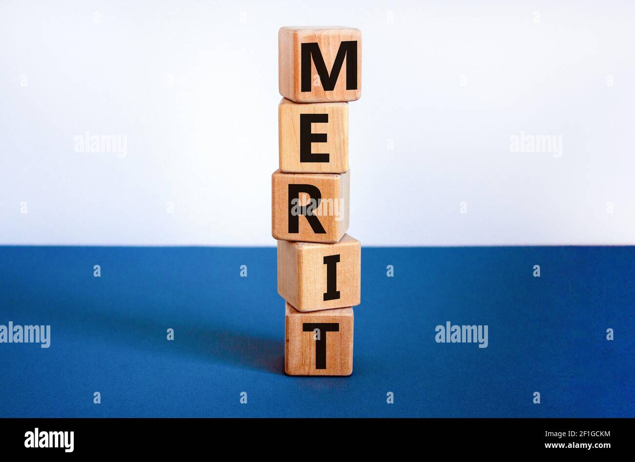 Merit symbol. Wooden cubes with the word 'merit'. Beautiful white and ...