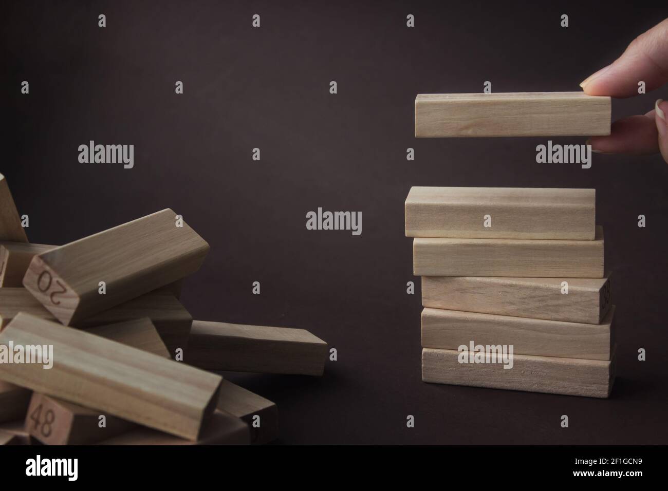 Hand build wood block in tower, symbolizing building success. Business ...