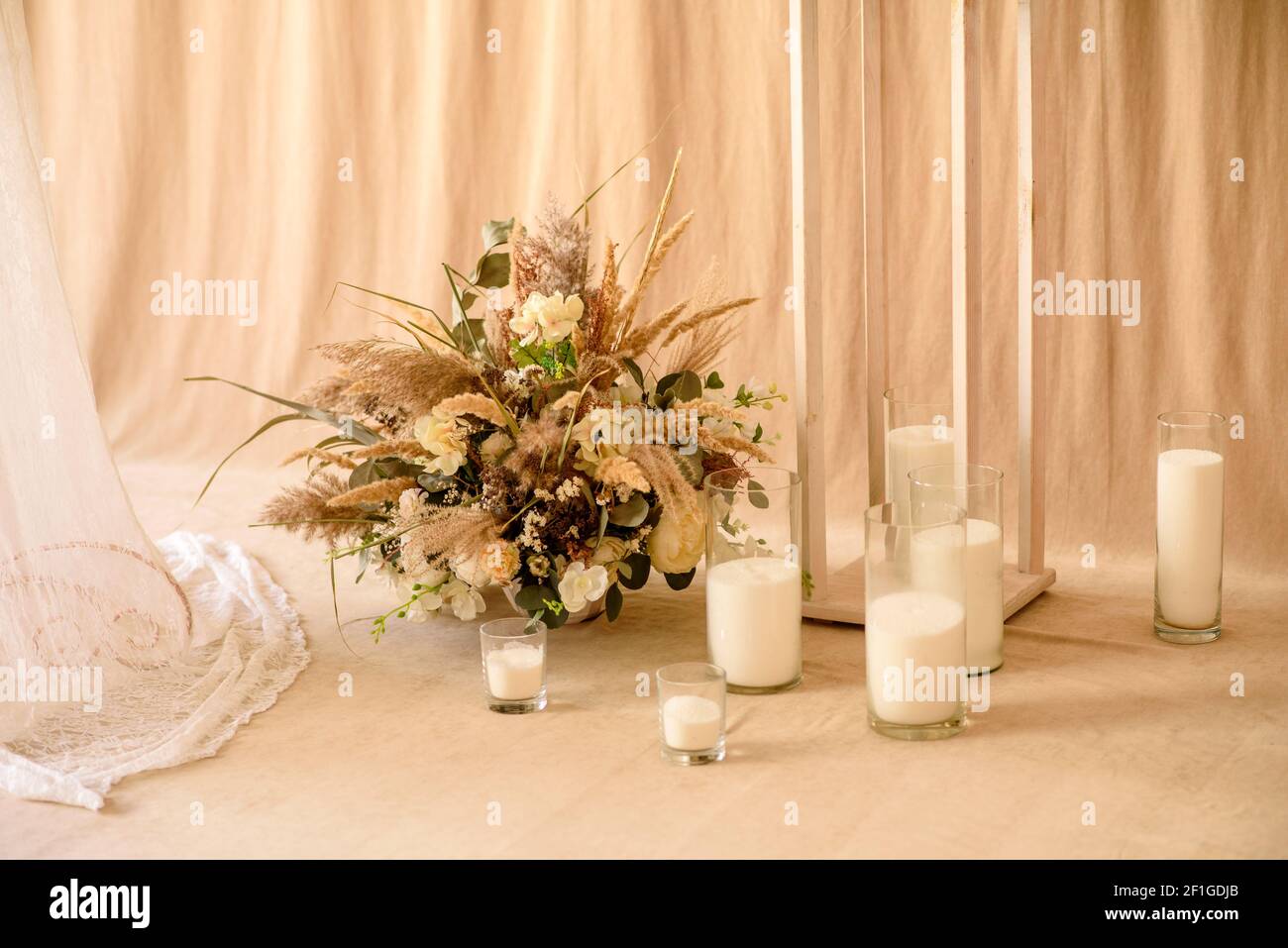 Decorations from dry beautiful flowers in a white vase on a beige ...