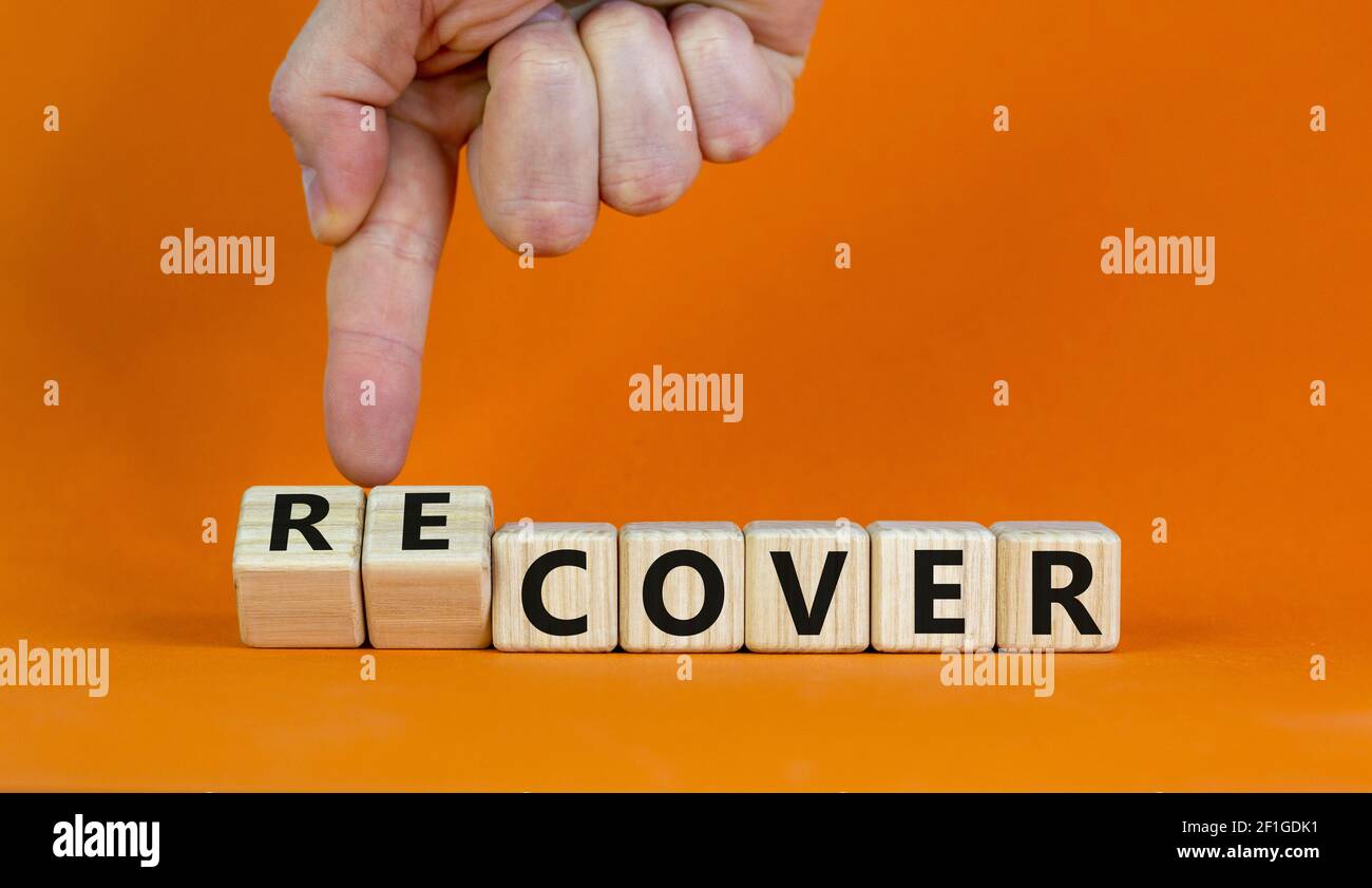 Time to recover symbol. Businessman turns wooden cubes and changes the ...