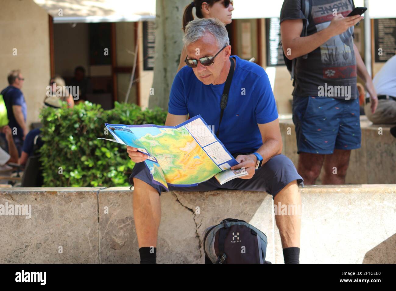 Man in Mallorca looking at the town map of Soller Stock Photo - Alamy
