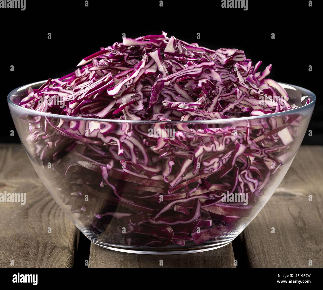 Shredded red cabbage on black background Stock Photo - Alamy