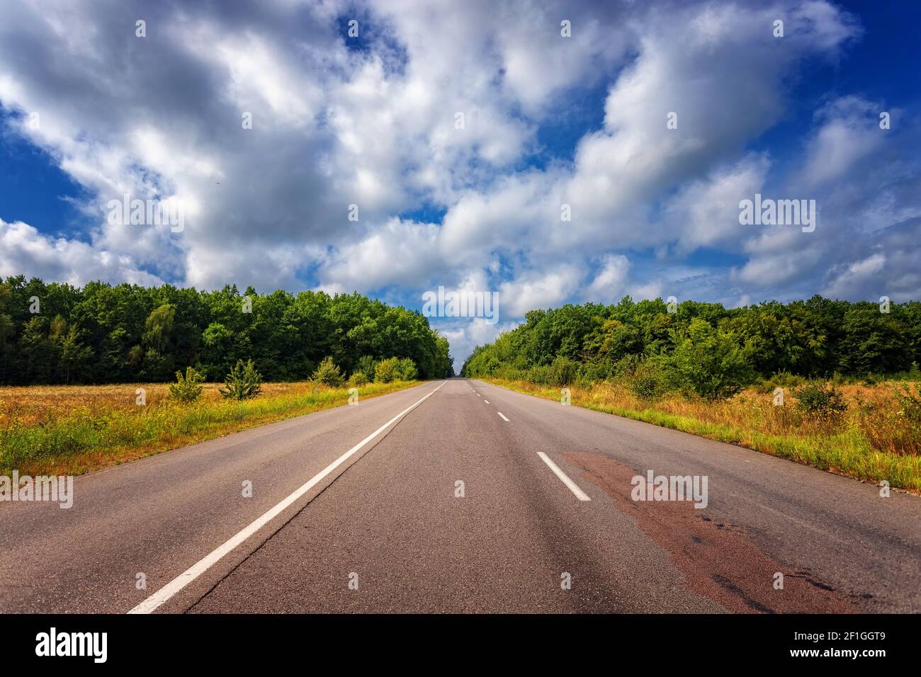 Empty summer highway in a hilly area, against the background of blue ...