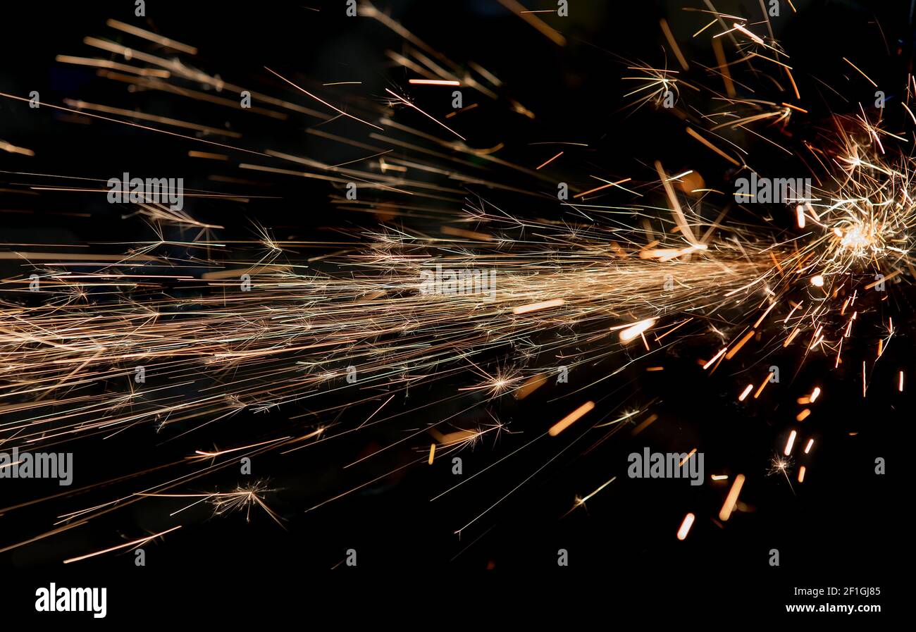bright sparks of metal against dark background Stock Photo - Alamy