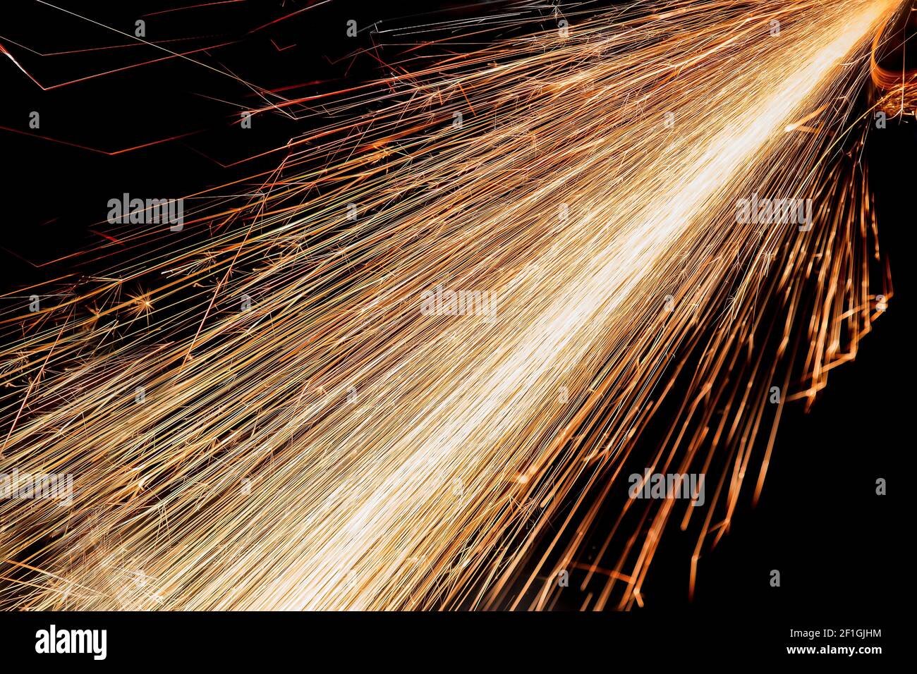 bright sparks of metal against dark background Stock Photo - Alamy