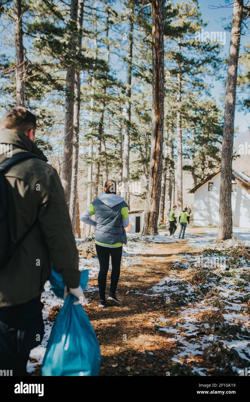 A vertical shot of a group of people hiking in the forest Stock Photo ...
