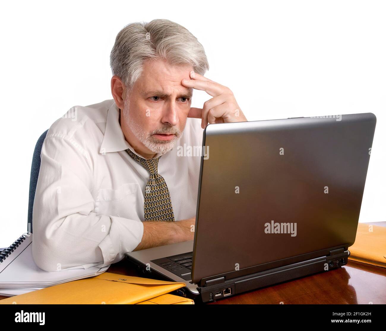 Horizontal shot of tired looking boomer businessman looking at his ...