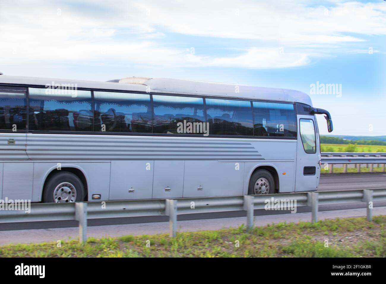 white bus goes on country highway Stock Photo - Alamy
