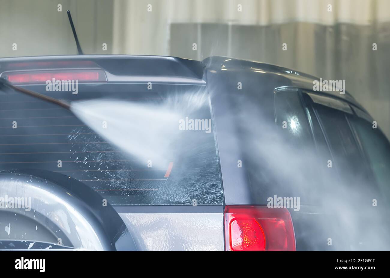 Car on a sink under a stream of water in a foam Stock Photo - Alamy