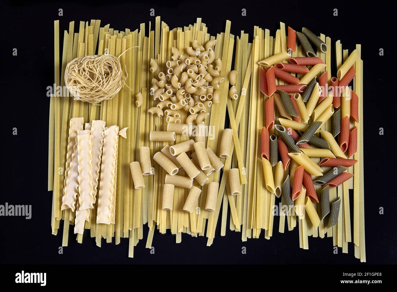 A top view of the variety of types and shapes of dry Italian pasta on ...