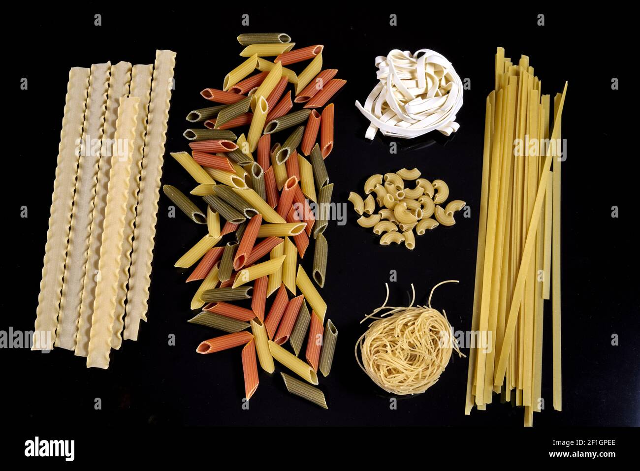 A top view of the variety of types and shapes of dry Italian pasta on ...