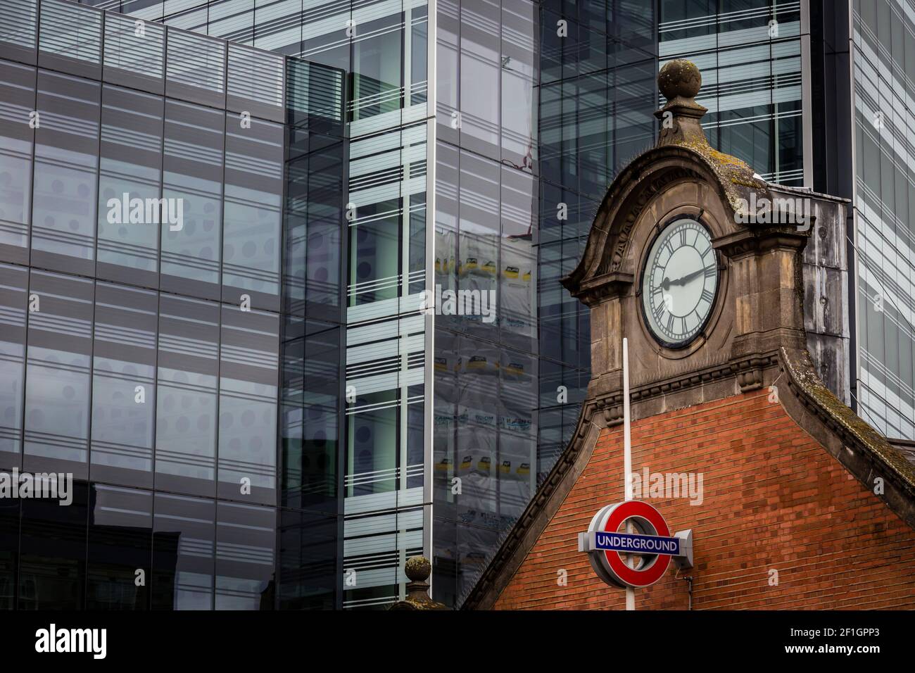 The red brick façade of the old Hammersmith Tube Station clock tower ...