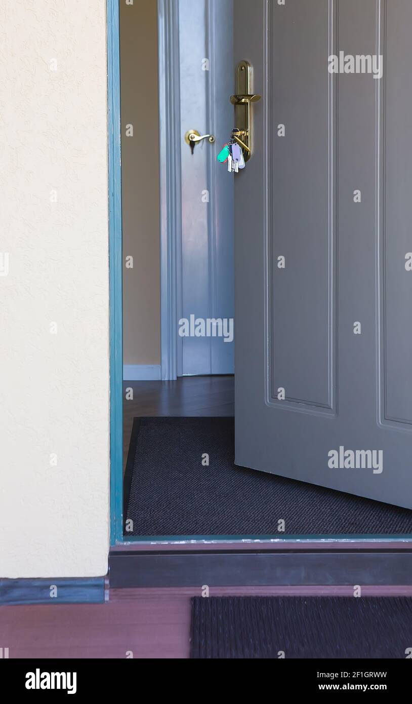 open wooden door of an entrance to house with keys in lock Stock Photo ...