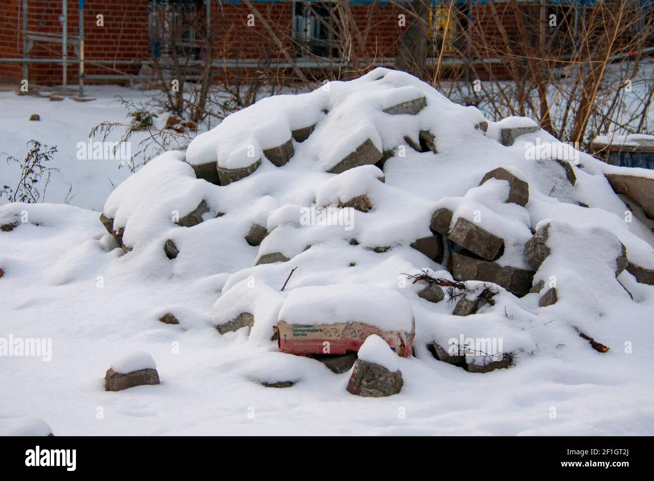 Snow covered pile of bricks during a blizzard Berlin Stock Photo - Alamy