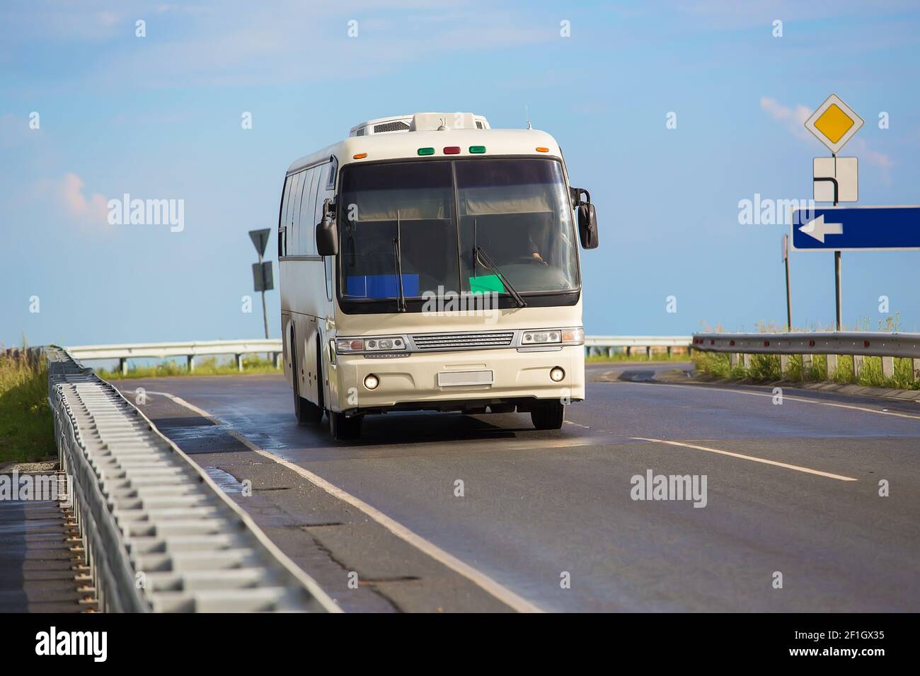 white bus goes on country highway Stock Photo - Alamy