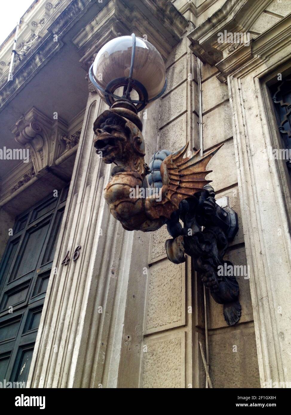 Dragon-shaped wrought iron street lamp on a palace in Rome Stock Photo ...