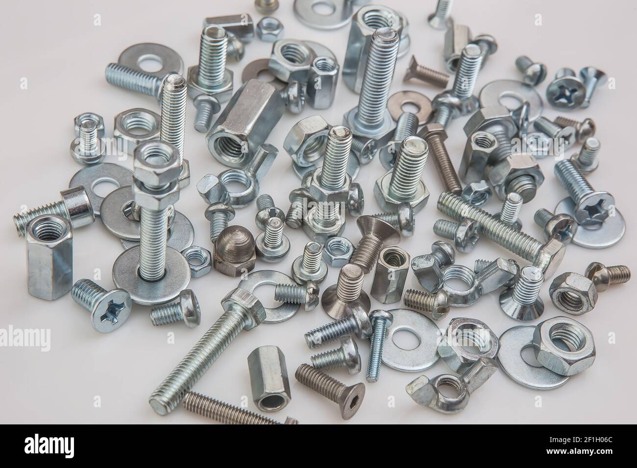 chromeplated bolts and nuts on white background Stock Photo - Alamy