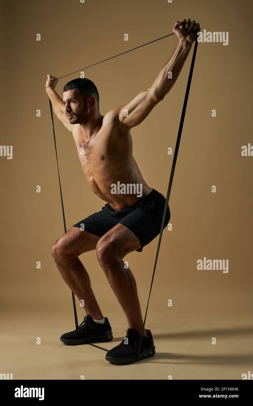 Full length side view portrait of handsome sportsman with muscular body ...