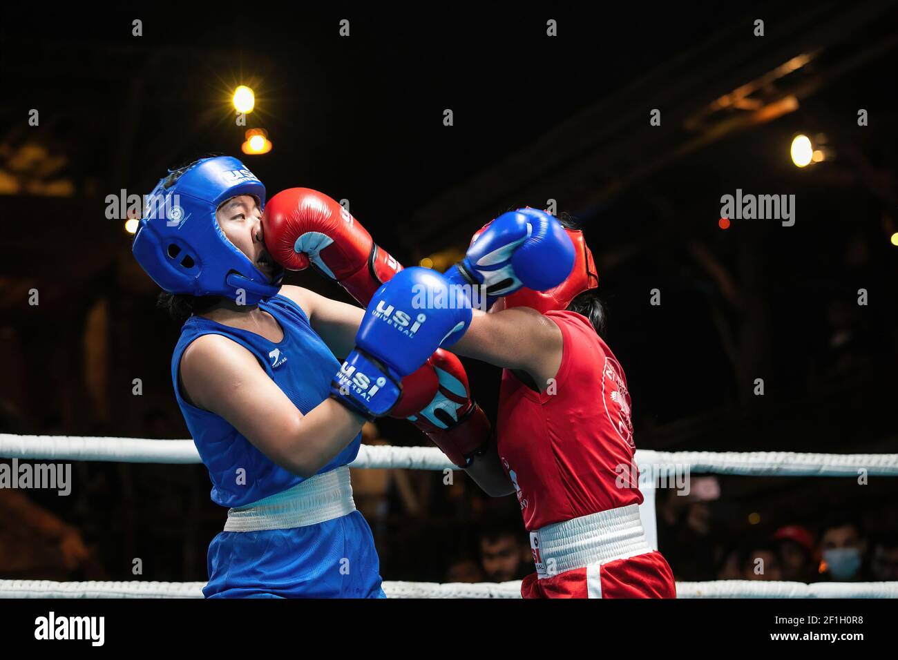 Nepalese woman boxer in red jersey Ambika Ghattraj punches Hema Rai ...