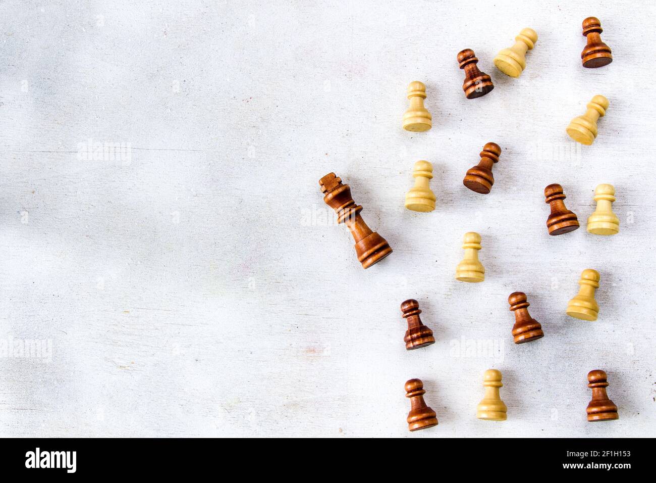 A top view of small wooden chess figures of both sides horizontally put ...
