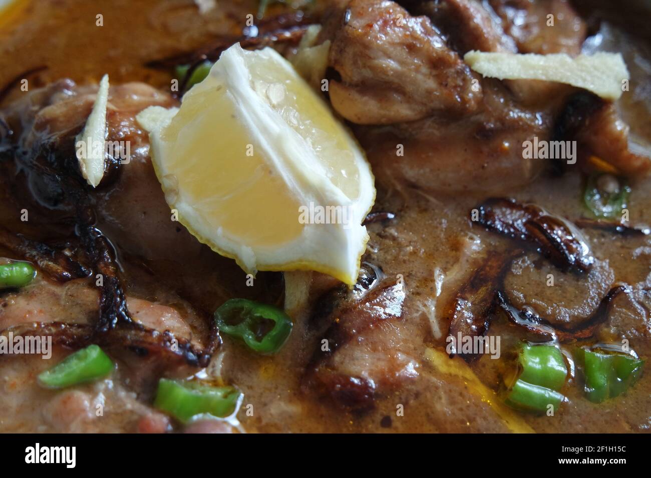 A traditional Pakistani Haleem dish with salad and lemon juice Stock ...