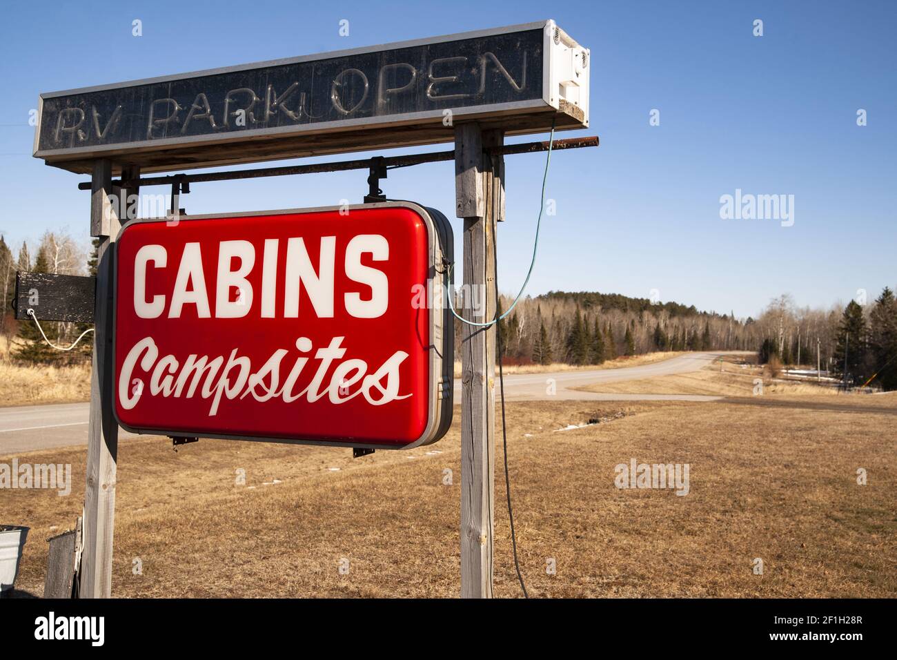 A Red Hanging Neon Roadside Sign Says Cabins and Campsites Stock Photo ...