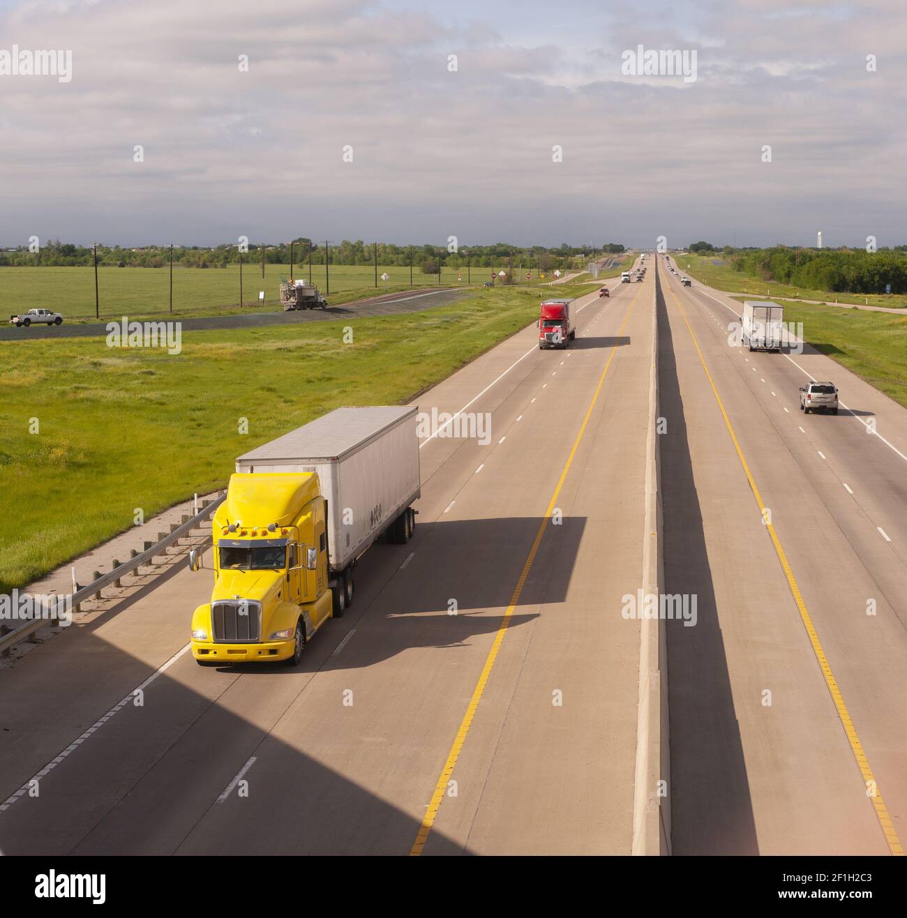 Yellow Semi Truck Trailer Rig Hauls Freight on Divided Highway Stock ...