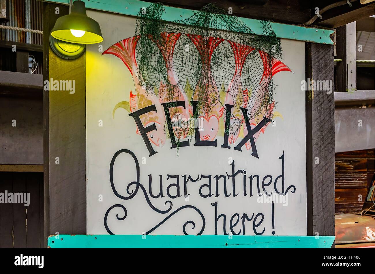 A quarantine sign hangs on the wall outside Felix’s Fish Camp ...