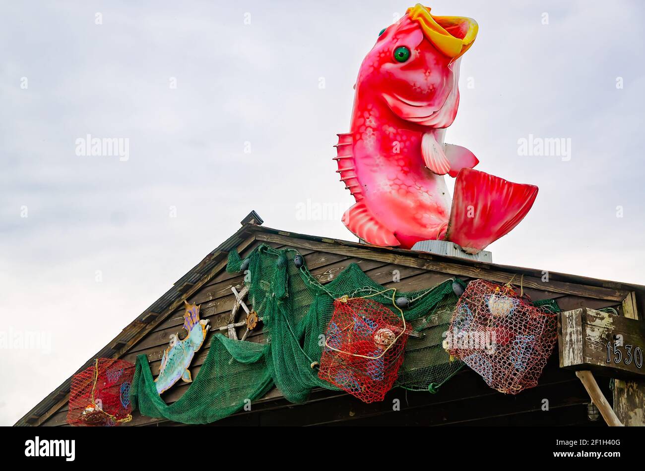 A large fish, nets, crab traps, and other nautical items are displayed ...