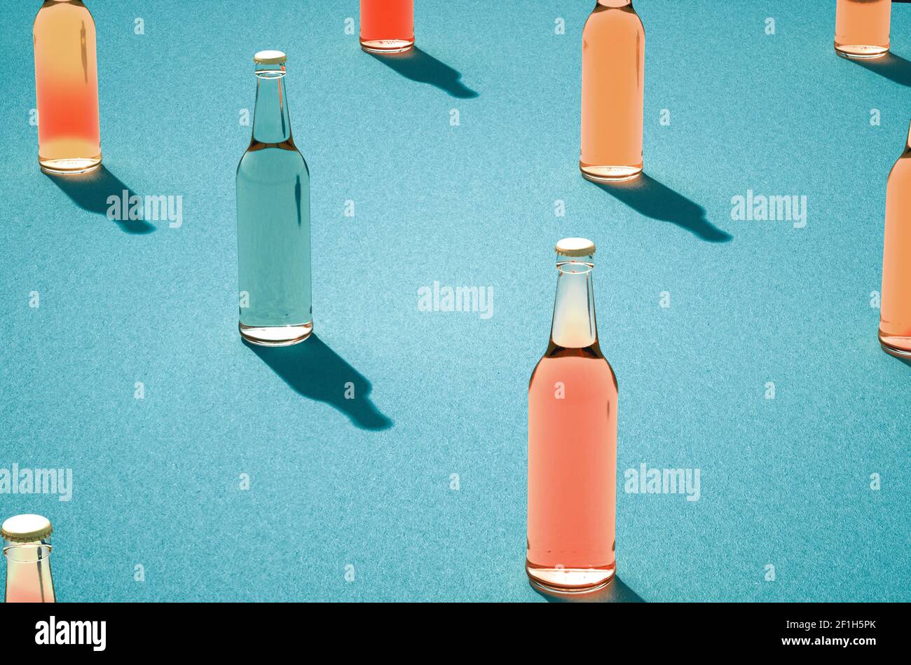 Several glass beer bottles with shadows on light blue background. Full ...