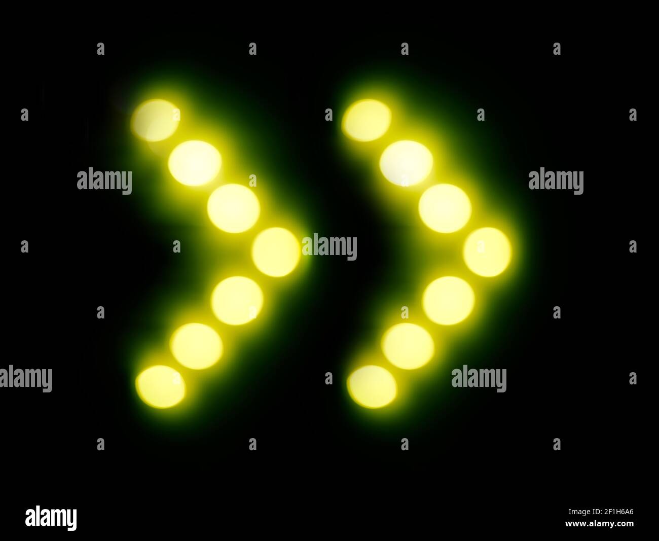 green neon arrow pointer, directional sign from the natural bokeh ...