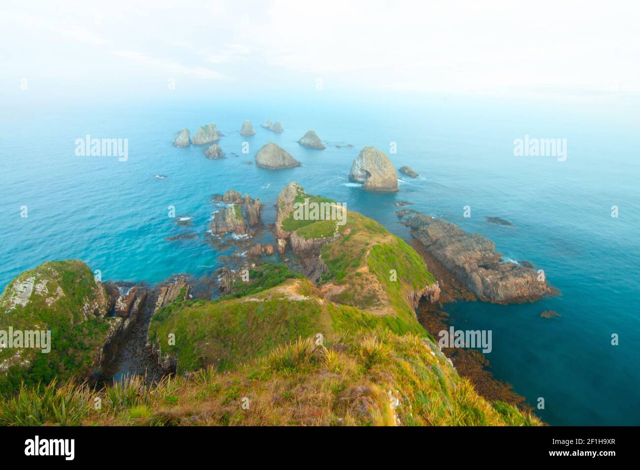 The nuggets, rocky islets of Nugget Point disappearing in the abstract ...