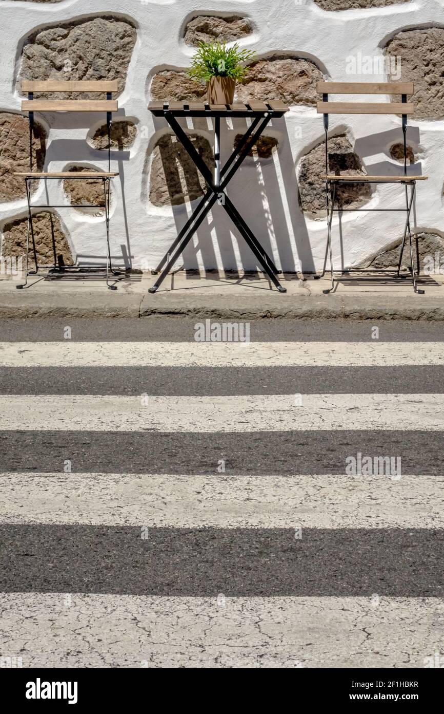 Empty table outside local cafe Stock Photo - Alamy